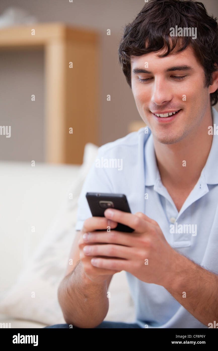 Smiling man writing textmessage Stock Photo - Alamy