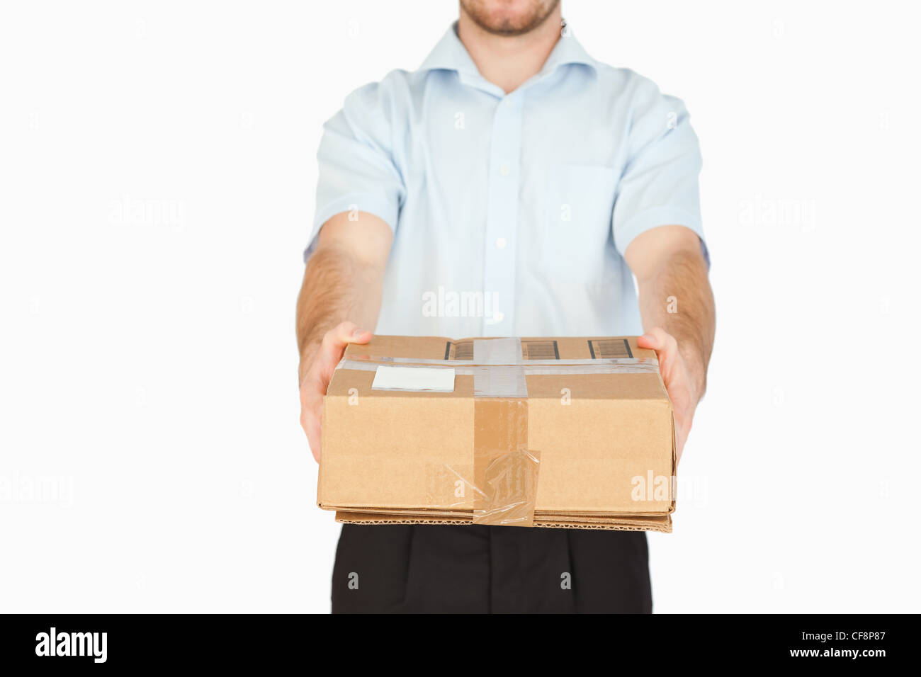 Parcel handed over by young post employee Stock Photo - Alamy