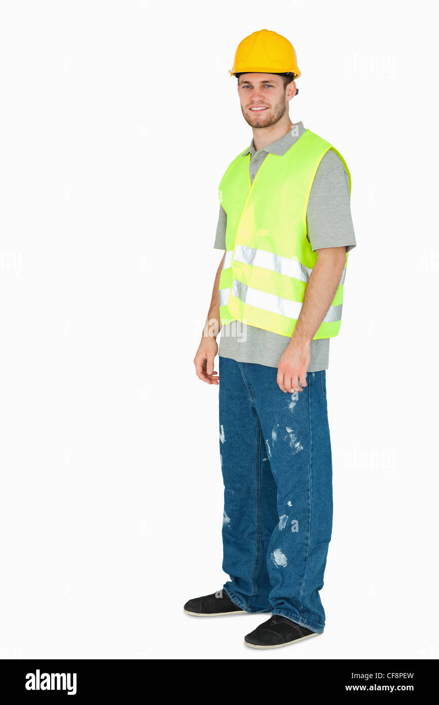 Side view of smiling young construction worker Stock Photo - Alamy