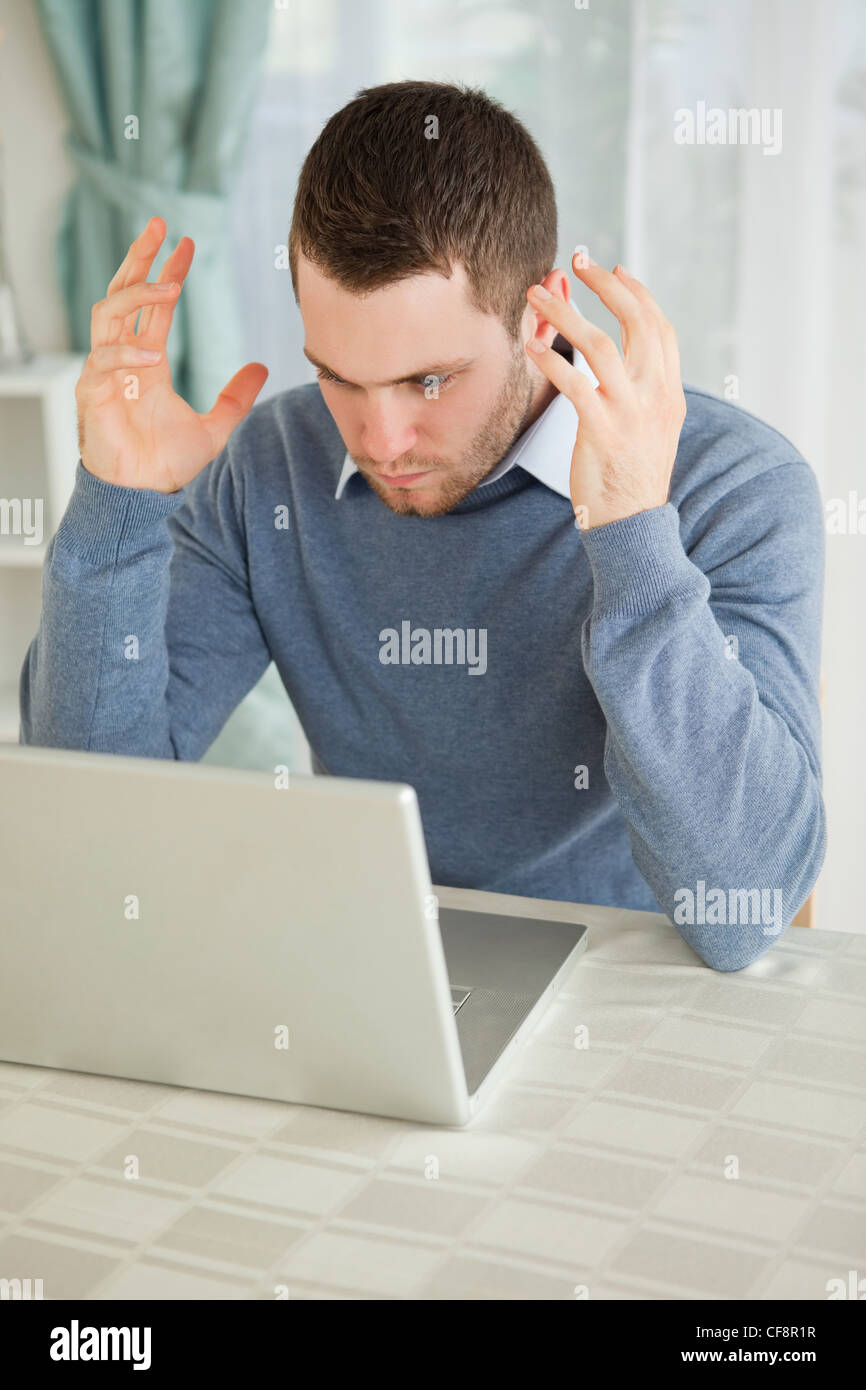 Businessman angry about his laptop in his homeoffice Stock Photo - Alamy