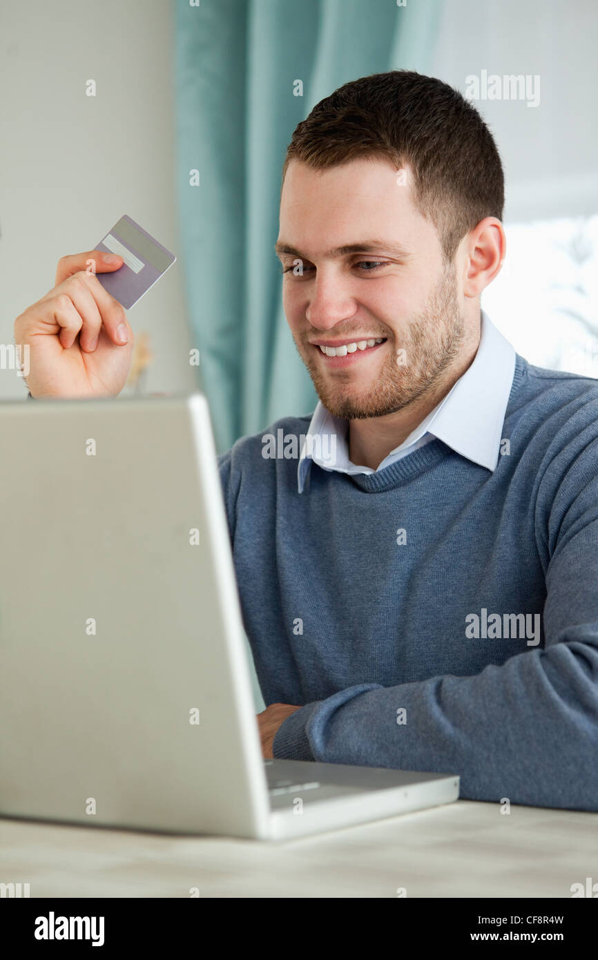 Man with his credit card on his laptop Stock Photo - Alamy