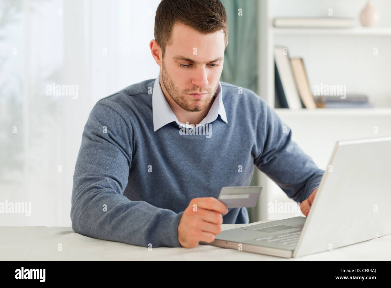 Male entering credit card information in his notebook Stock Photo - Alamy