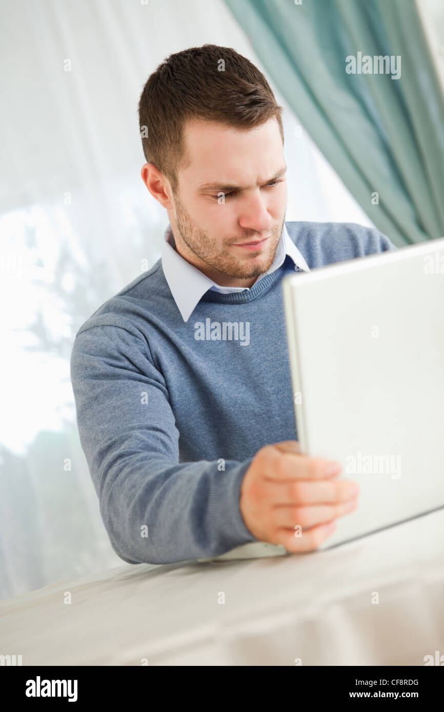 Businessman reading on his laptop Stock Photo - Alamy