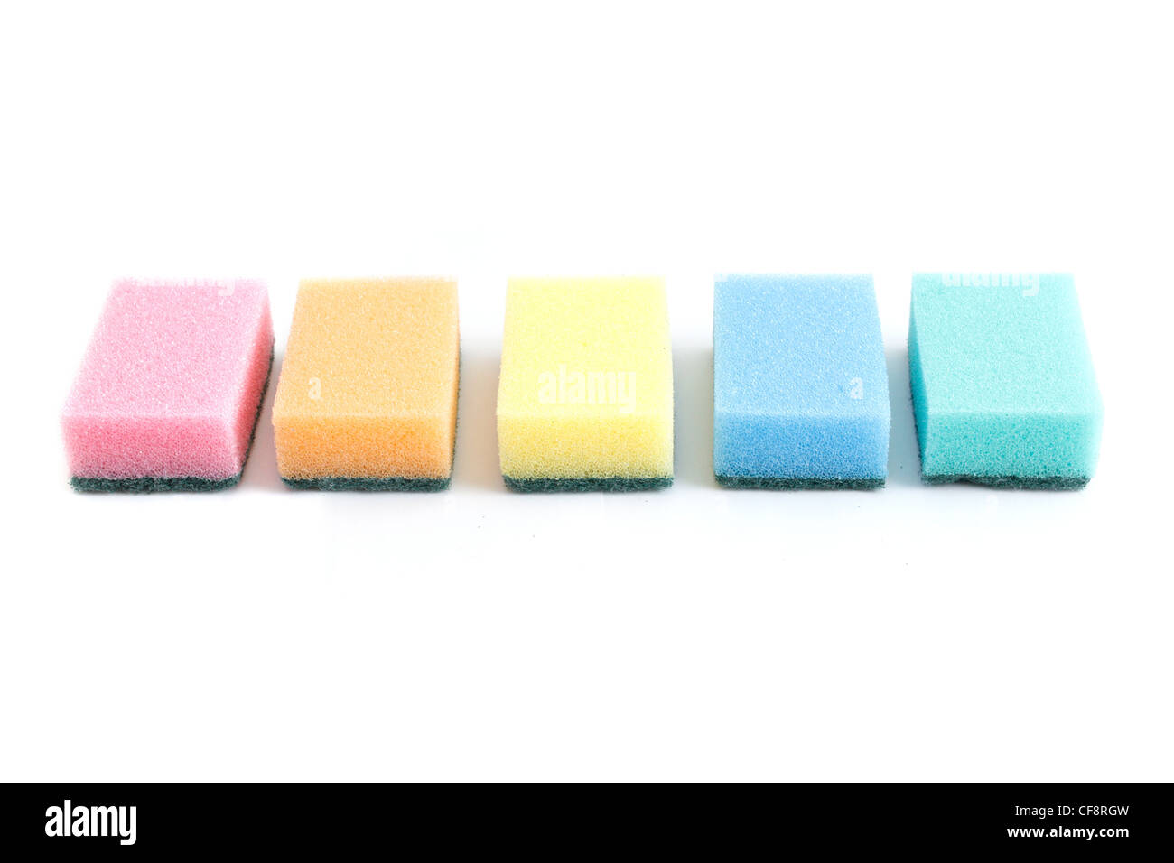 Colourful sponges isolated on a white bg Stock Photo - Alamy