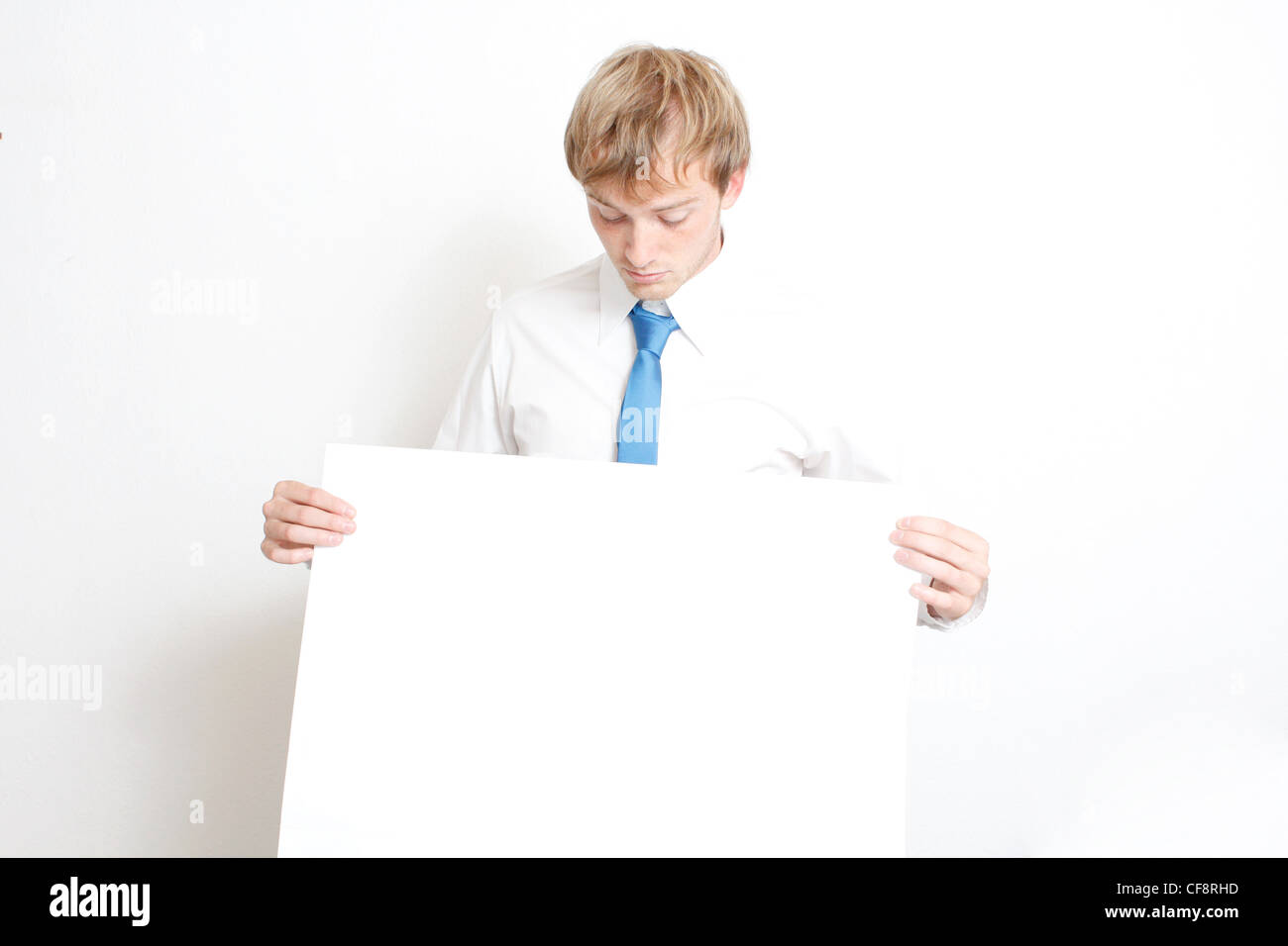 Business man looking down on sign Stock Photo - Alamy
