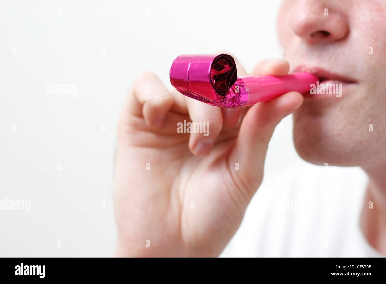 A person playing with party blowers Stock Photo - Alamy