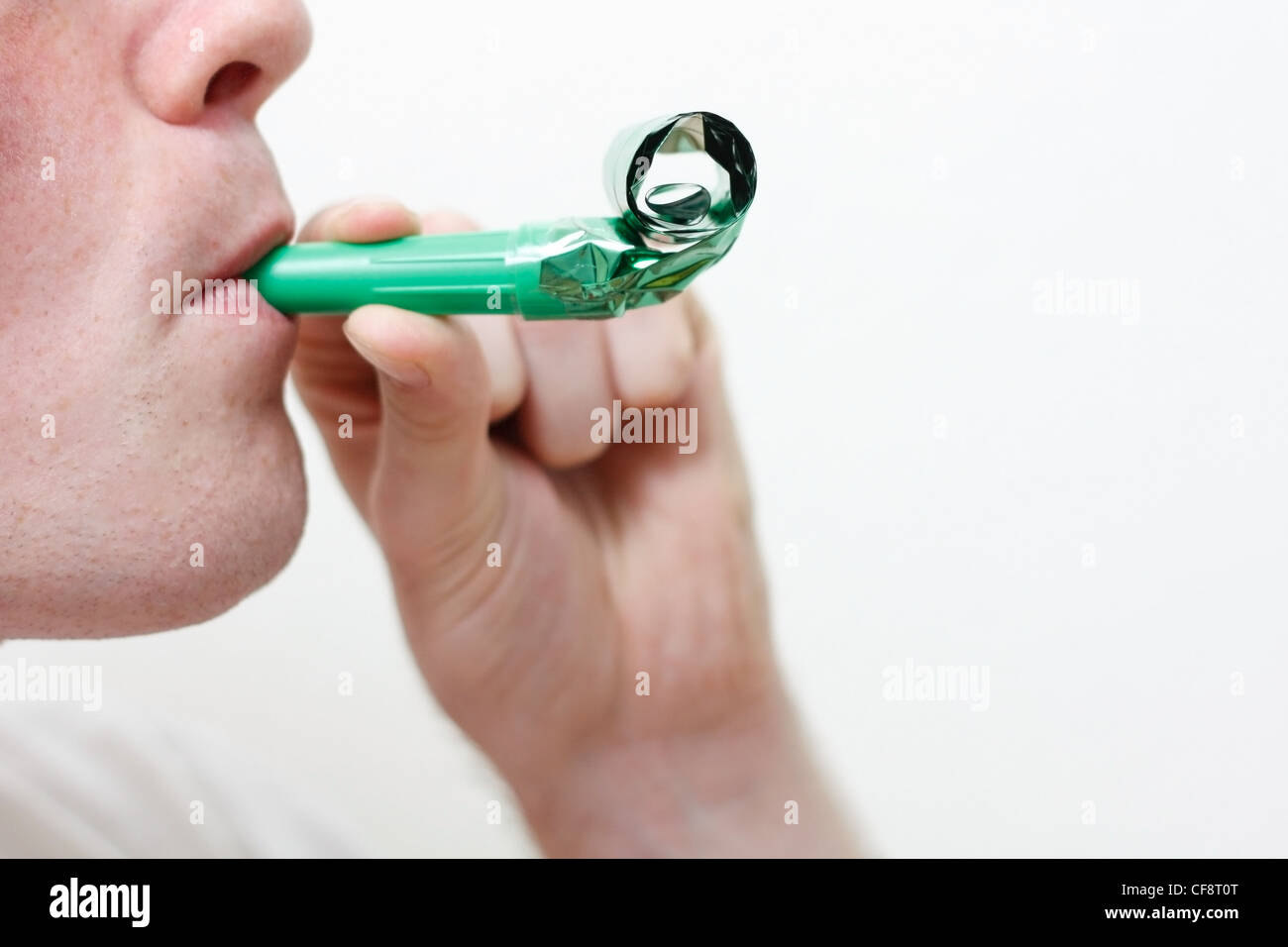 A person playing with party blowers Stock Photo - Alamy