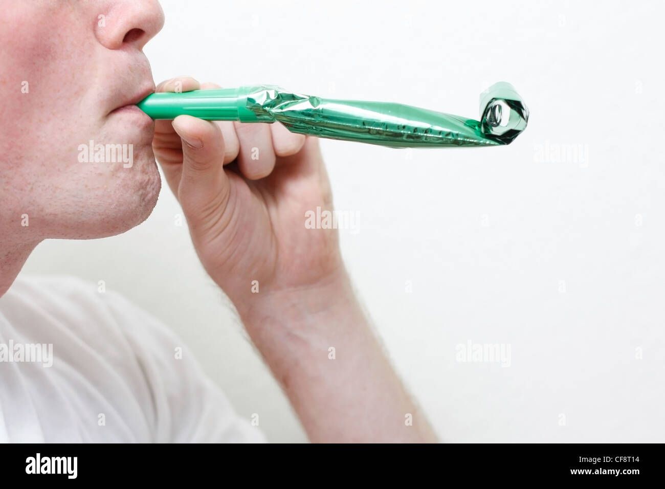 A person playing with party blowers Stock Photo - Alamy
