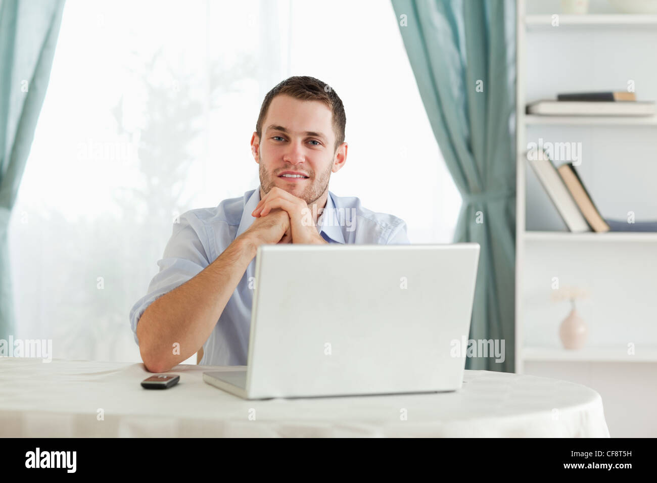 Businessman sitting behind his desk Stock Photo - Alamy
