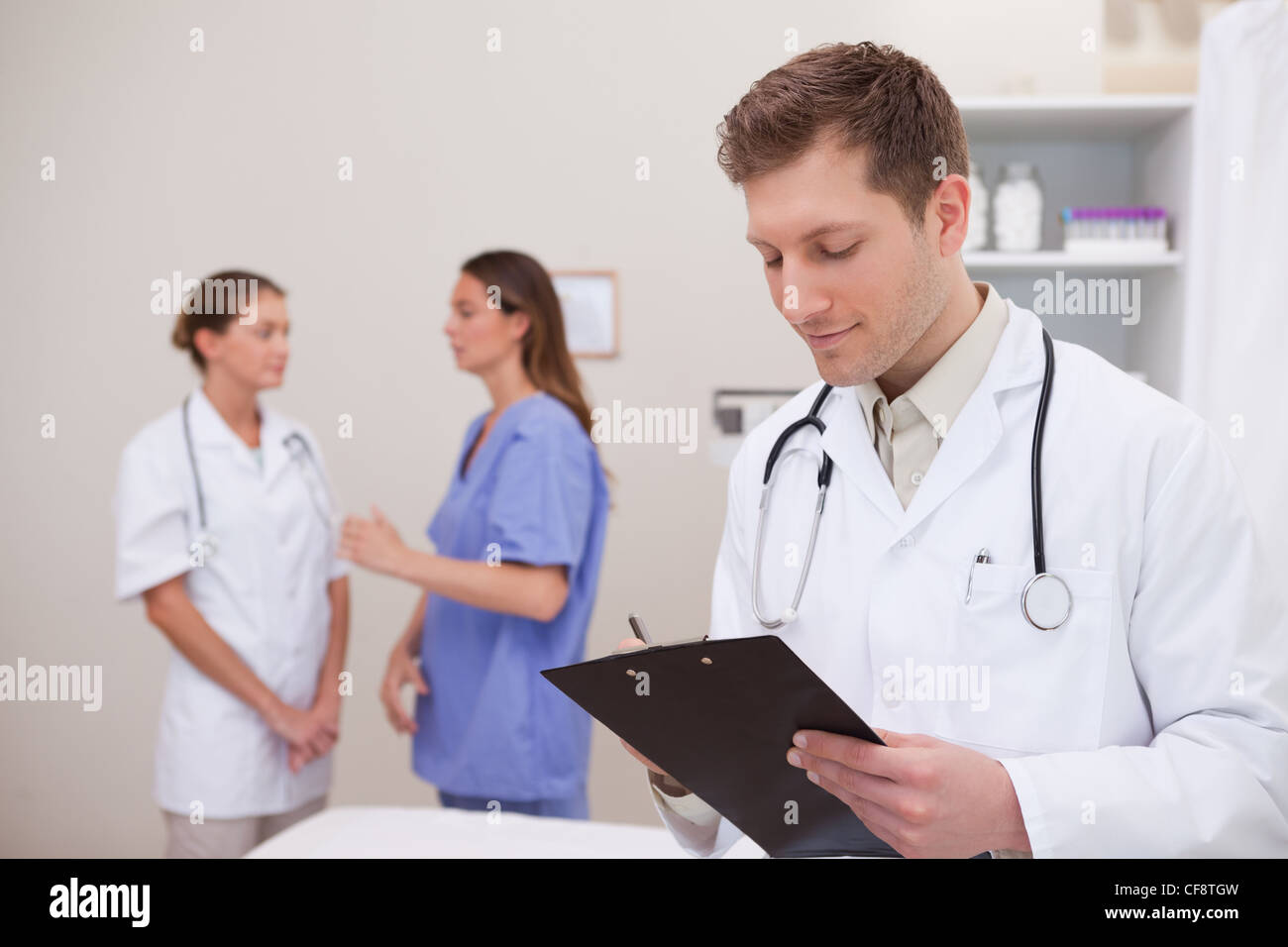 Doctor reading patients record Stock Photo - Alamy