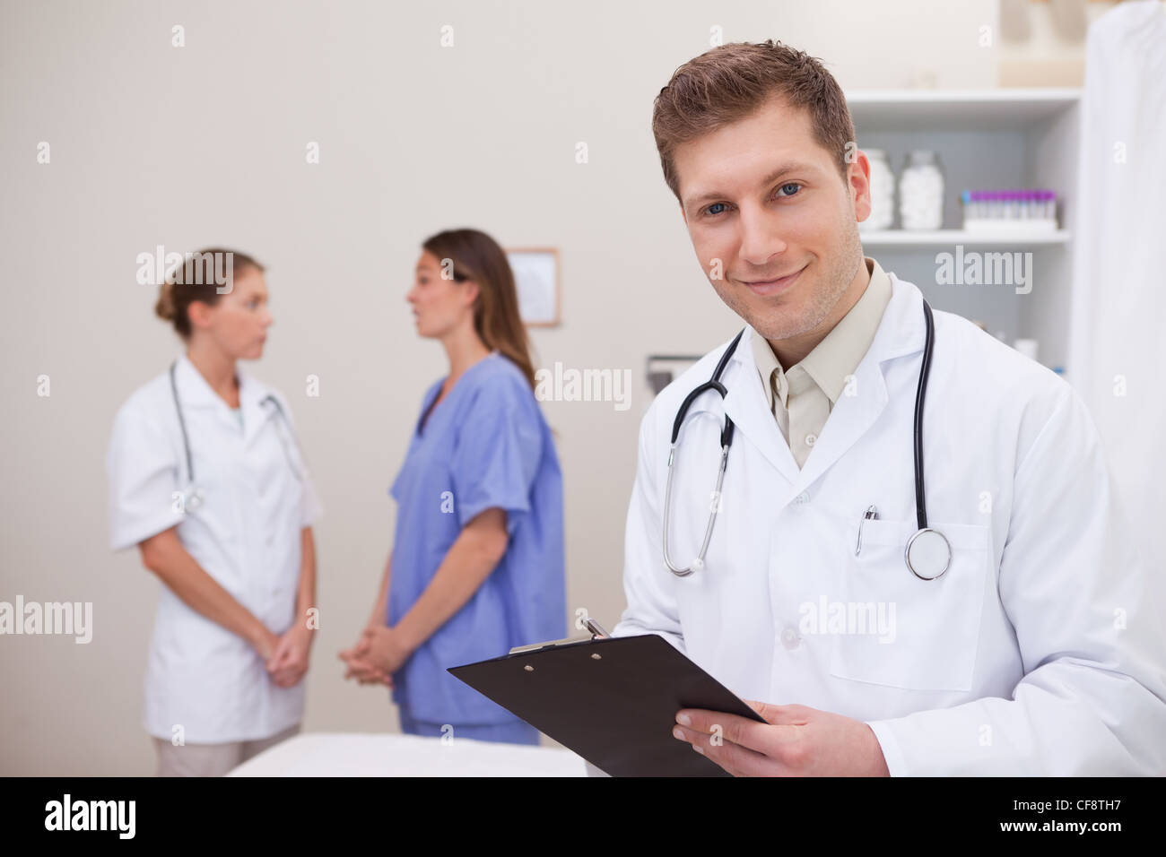 Doctor standing in examination room Stock Photo - Alamy