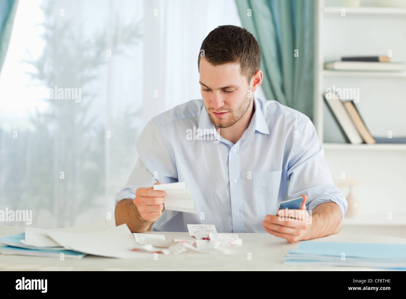 Man checking bills taxes home hi-res stock photography and images - Alamy