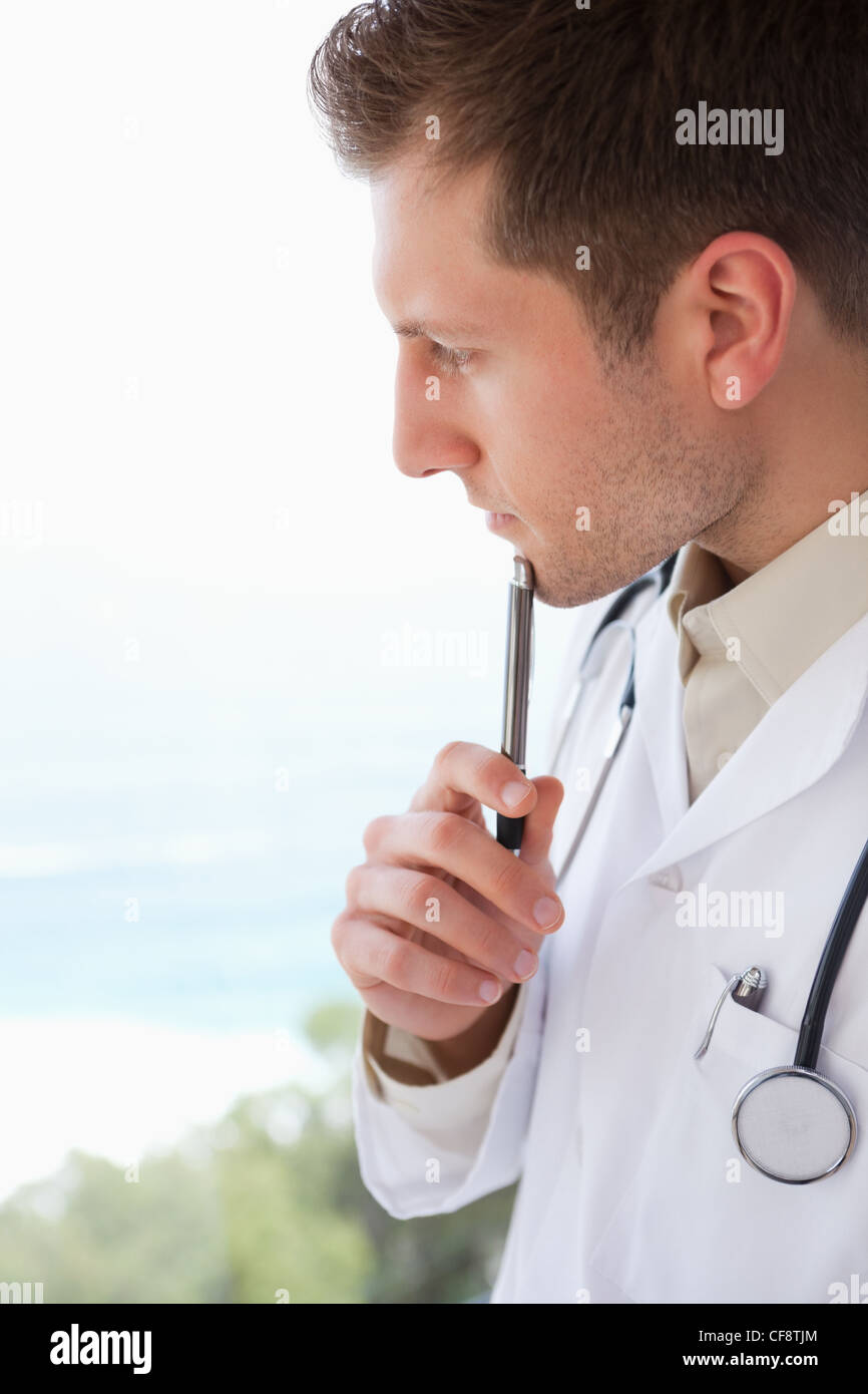 Side view of thinking doctor Stock Photo - Alamy