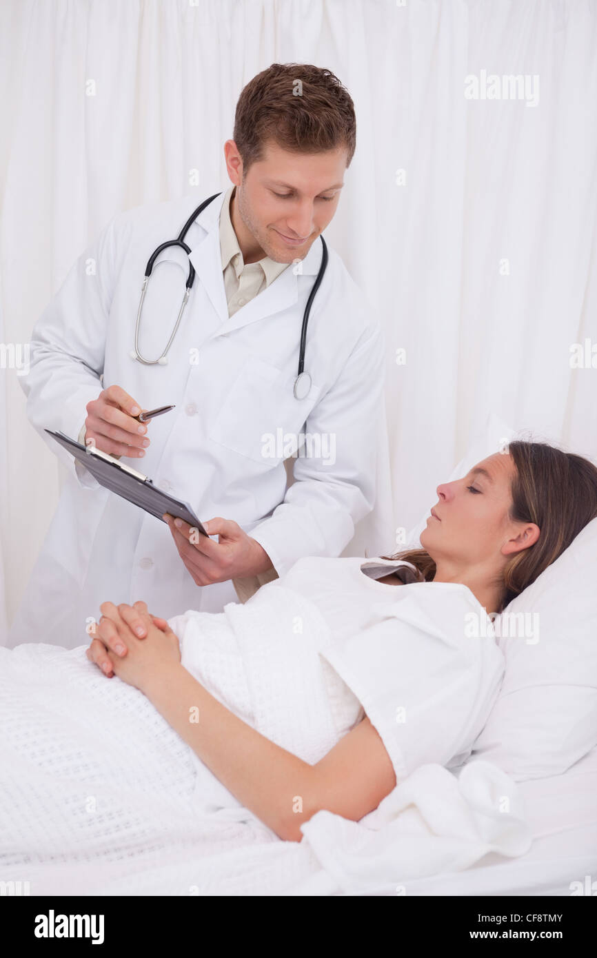 Doctor standing next to patient Stock Photo - Alamy