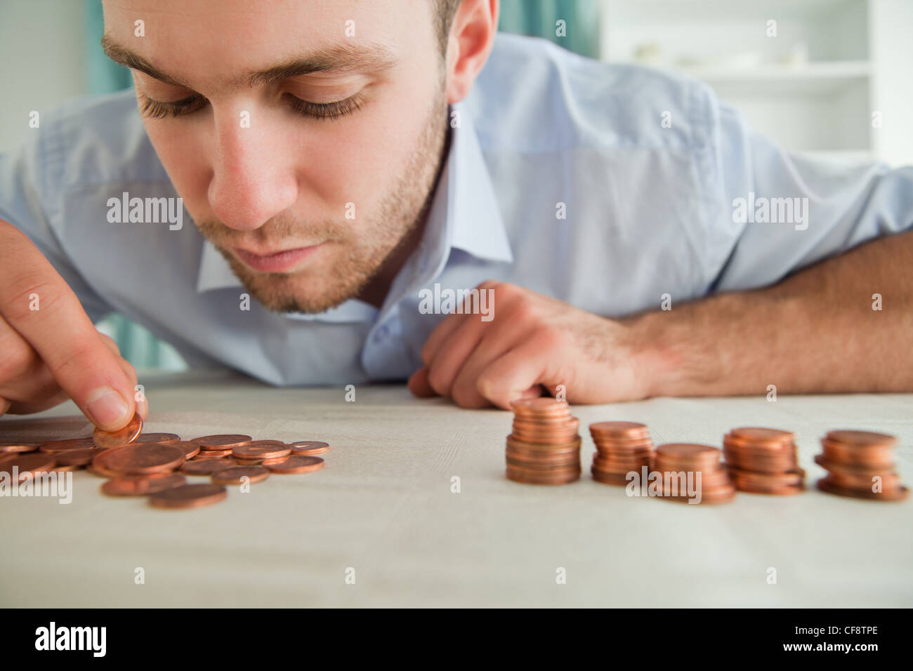 Businessman counting coins Stock Photo - Alamy