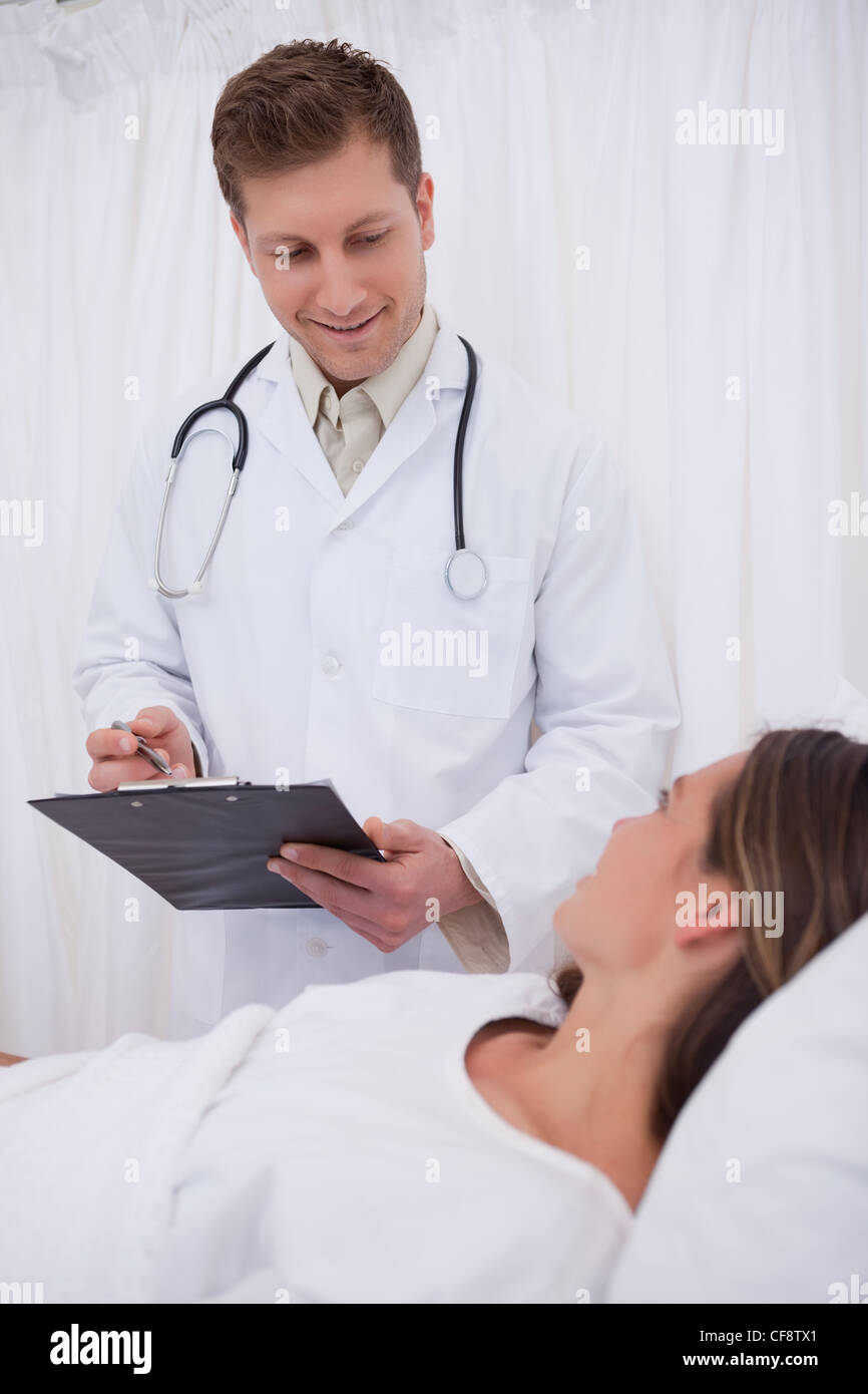 Doctor standing next to his patient Stock Photo - Alamy