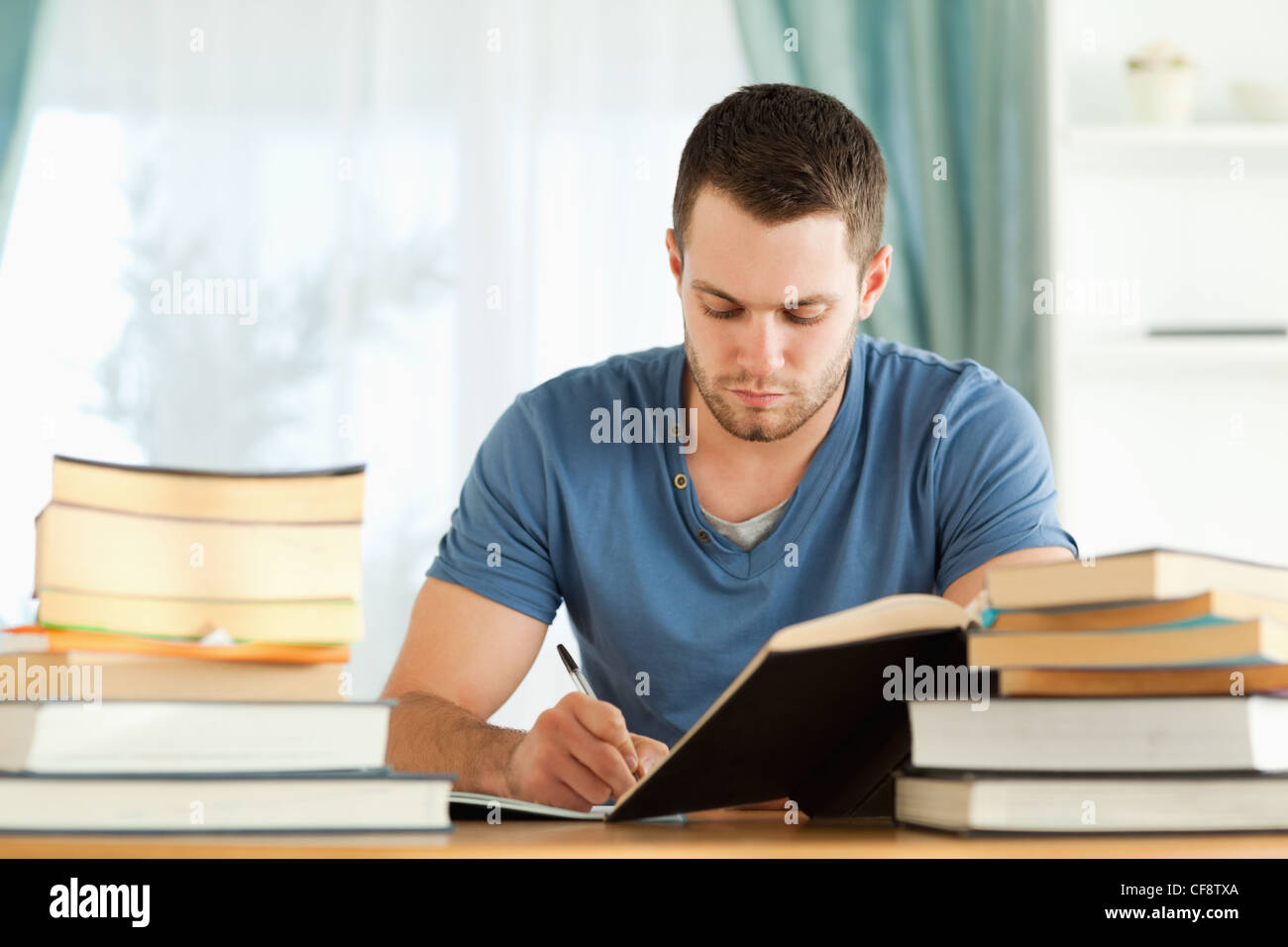 Student doing his homework Stock Photo - Alamy