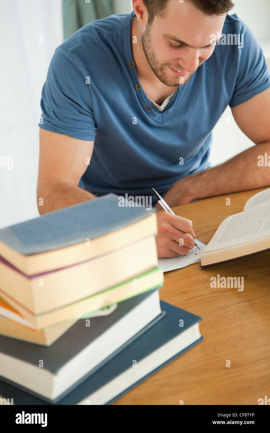 Smiling student doing book report Stock Photo - Alamy