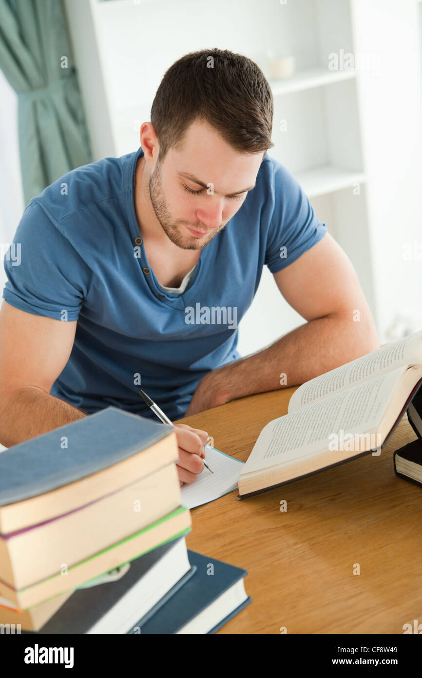 Student working hard on his book report Stock Photo - Alamy