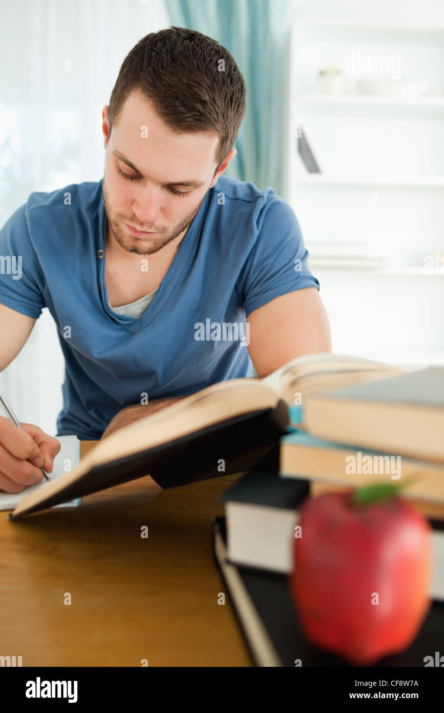 Focused student working on his assignment Stock Photo - Alamy
