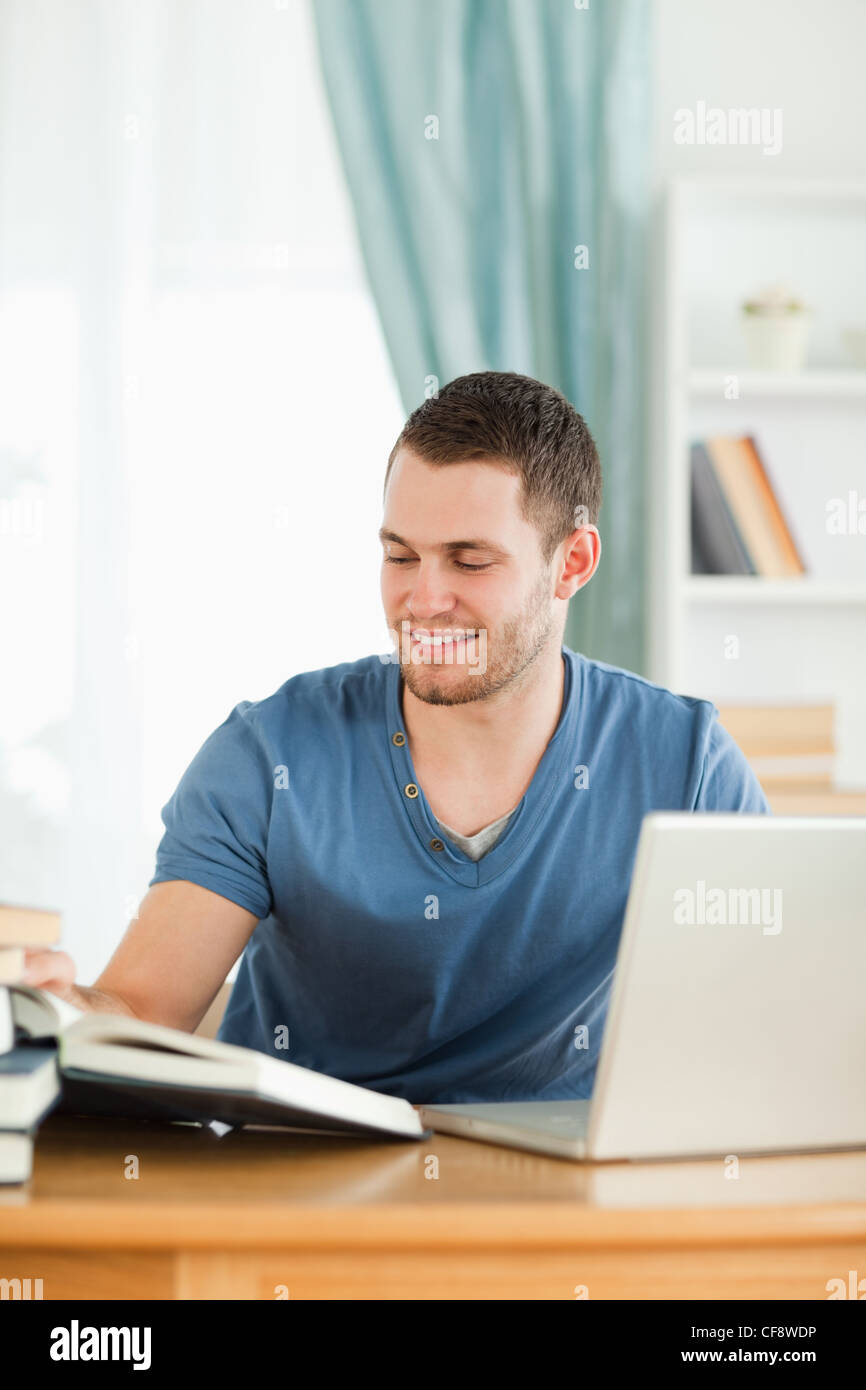 Student using the internet for his book report Stock Photo - Alamy