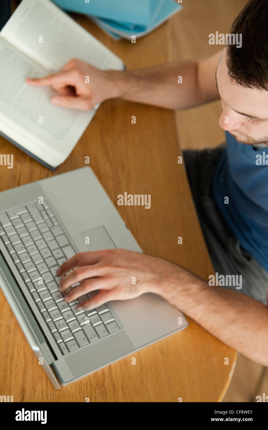 Student using notebook for his homework Stock Photo - Alamy