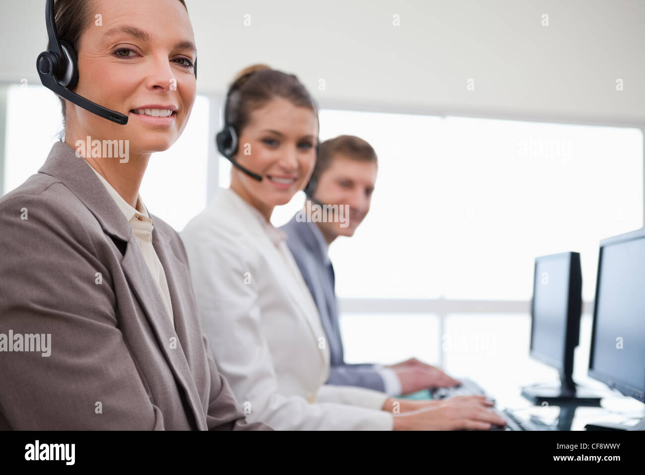 Side view of customer service team Stock Photo - Alamy