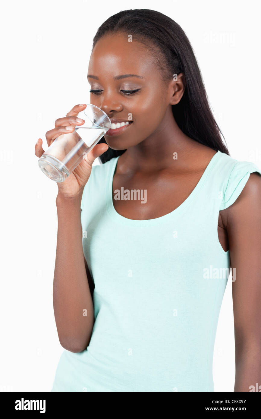 Young woman looking into her glass of water Stock Photo - Alamy