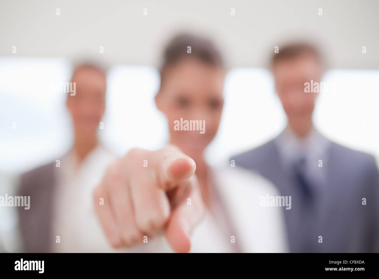 Personnel department team pointing at new employee Stock Photo - Alamy