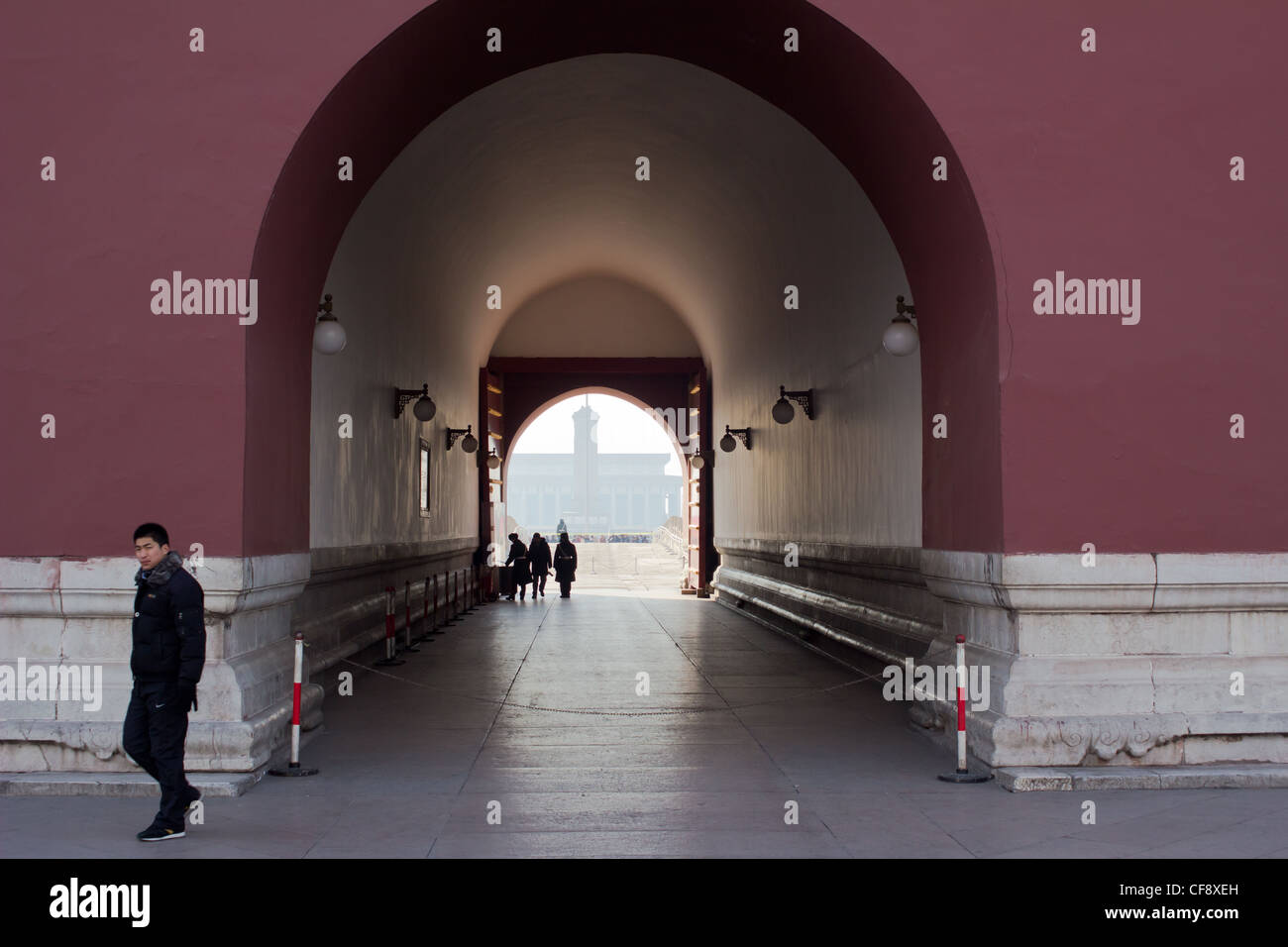 A man walking under the gate of Tiananmen Stock Photo - Alamy