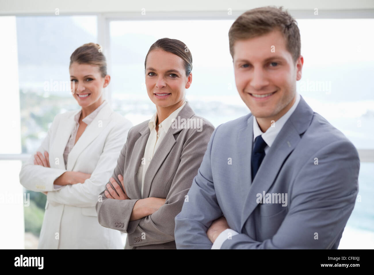 Marketing department with arms folded Stock Photo - Alamy