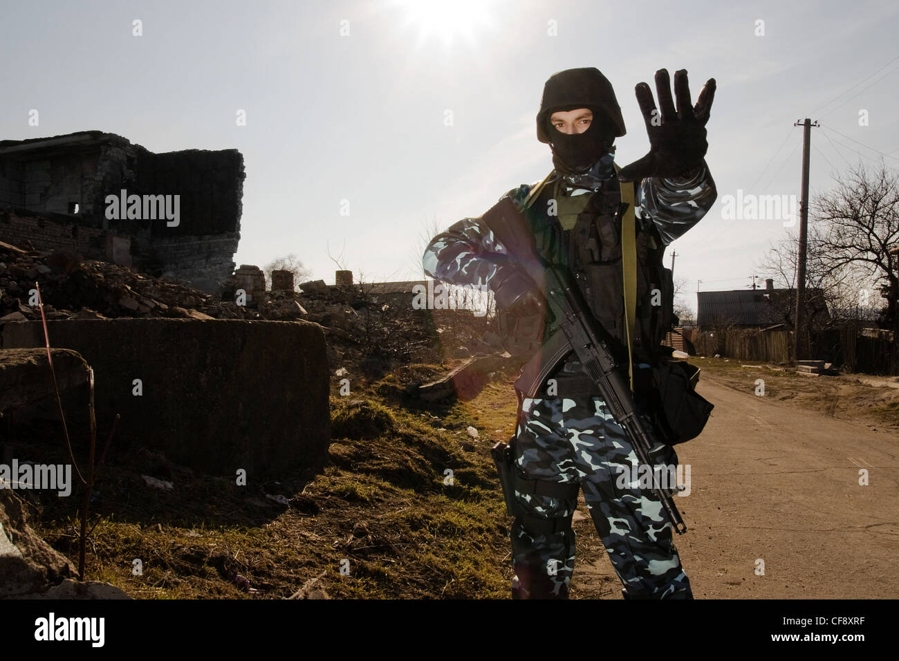 Armed military man gives you a signal to stop on the road Stock Photo ...