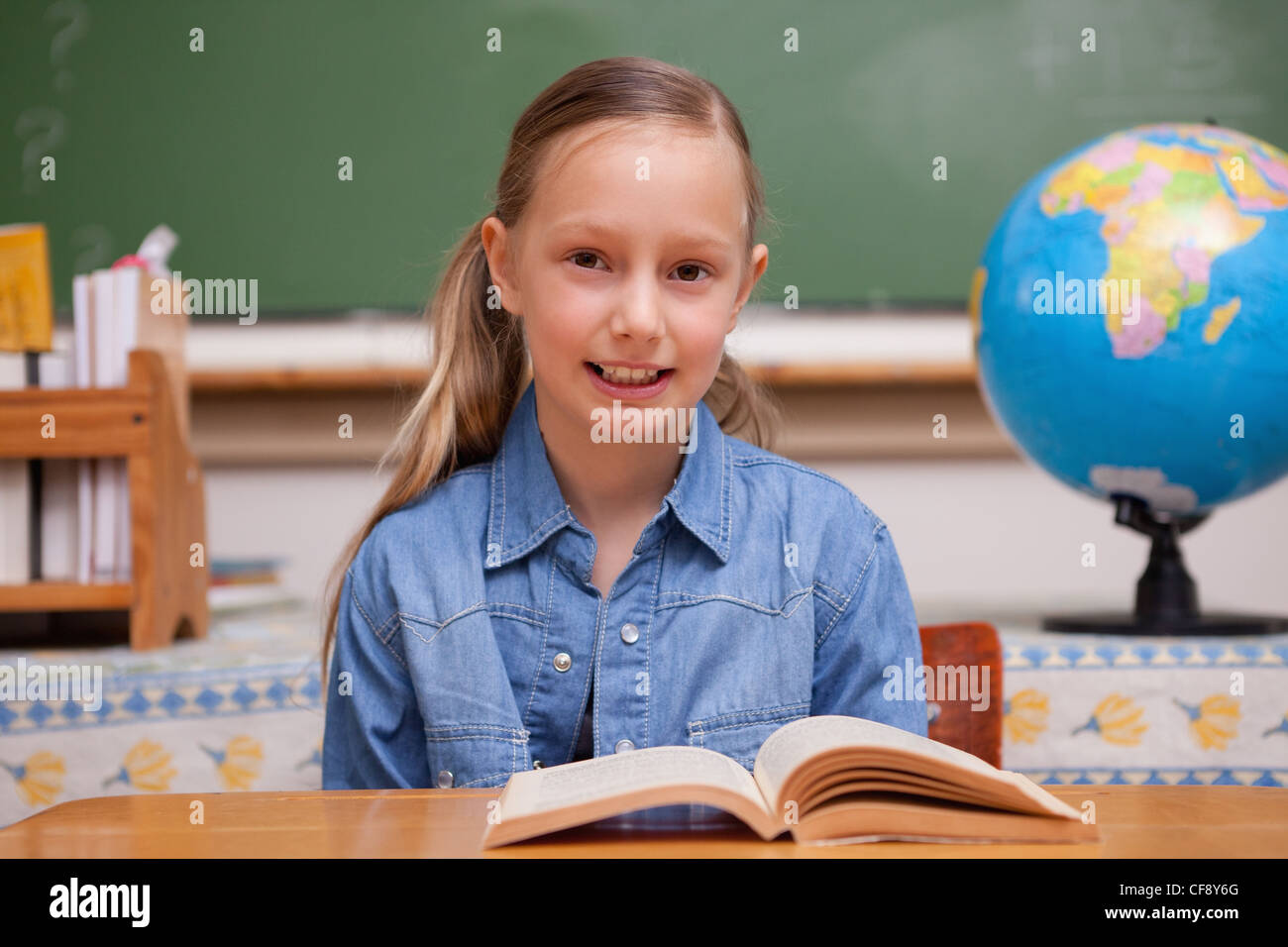 Schoolgirl reading a book Stock Photo - Alamy
