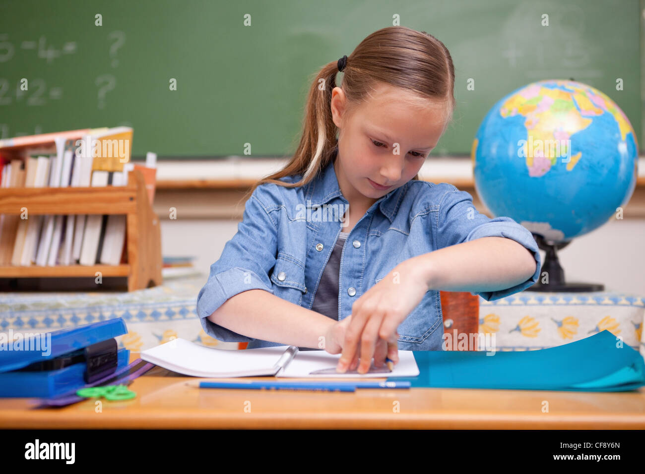Schoolgirl doing classwork Stock Photo - Alamy