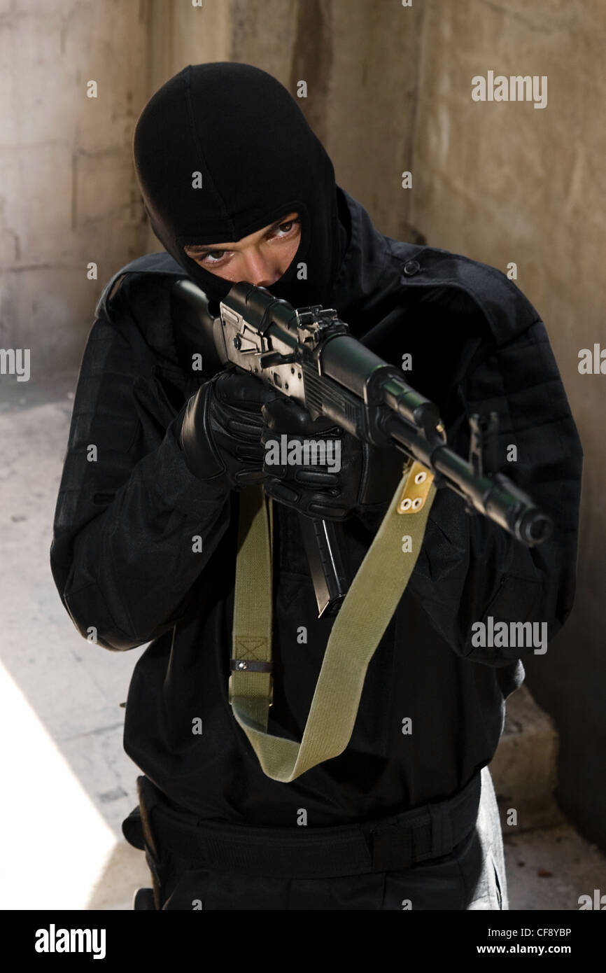 Gunman aiming his target with an automatic russian AK-47 rifle Stock ...