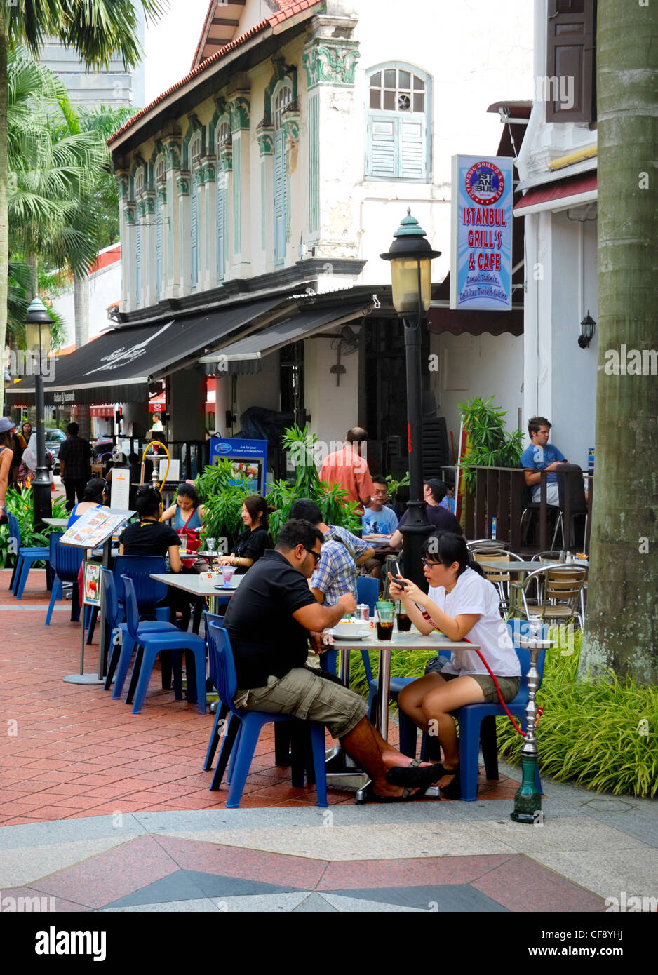 Diners eating at a restaurant in Bussorah Street, Singapore Stock Photo ...