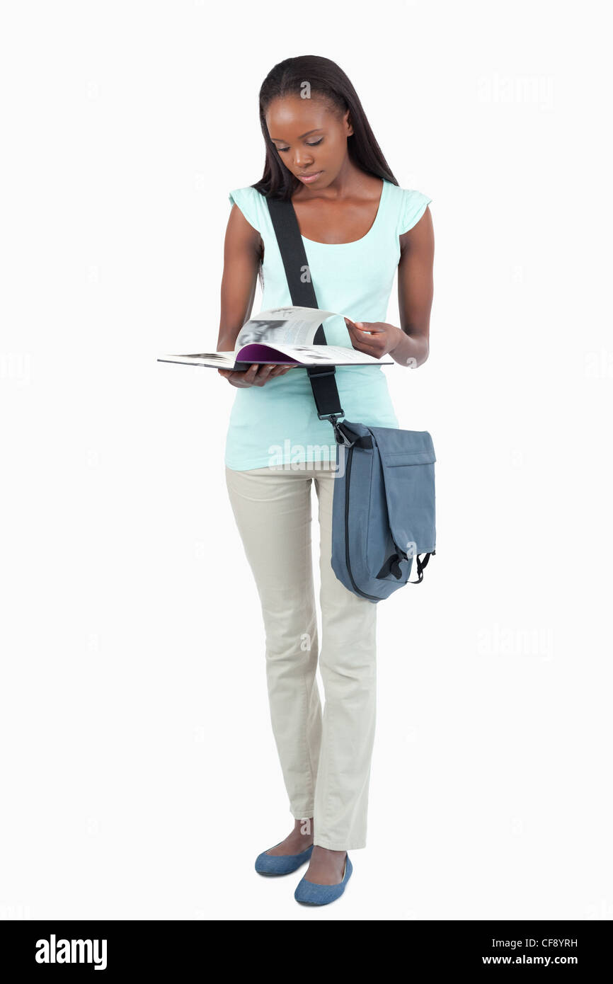 Young student having a look at her book Stock Photo - Alamy