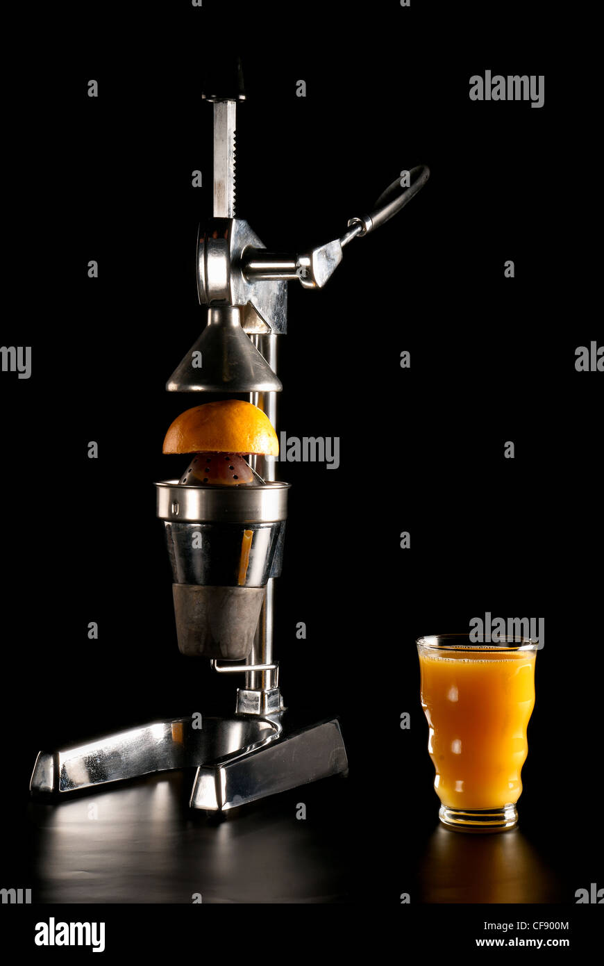 Classic metal juicer with gapefruit and juice Stock Photo - Alamy