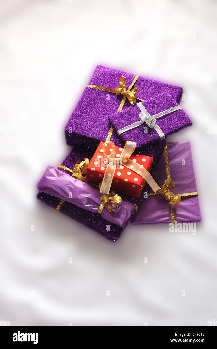 Odd one out - a collection of purple presents with one red spotty one ...