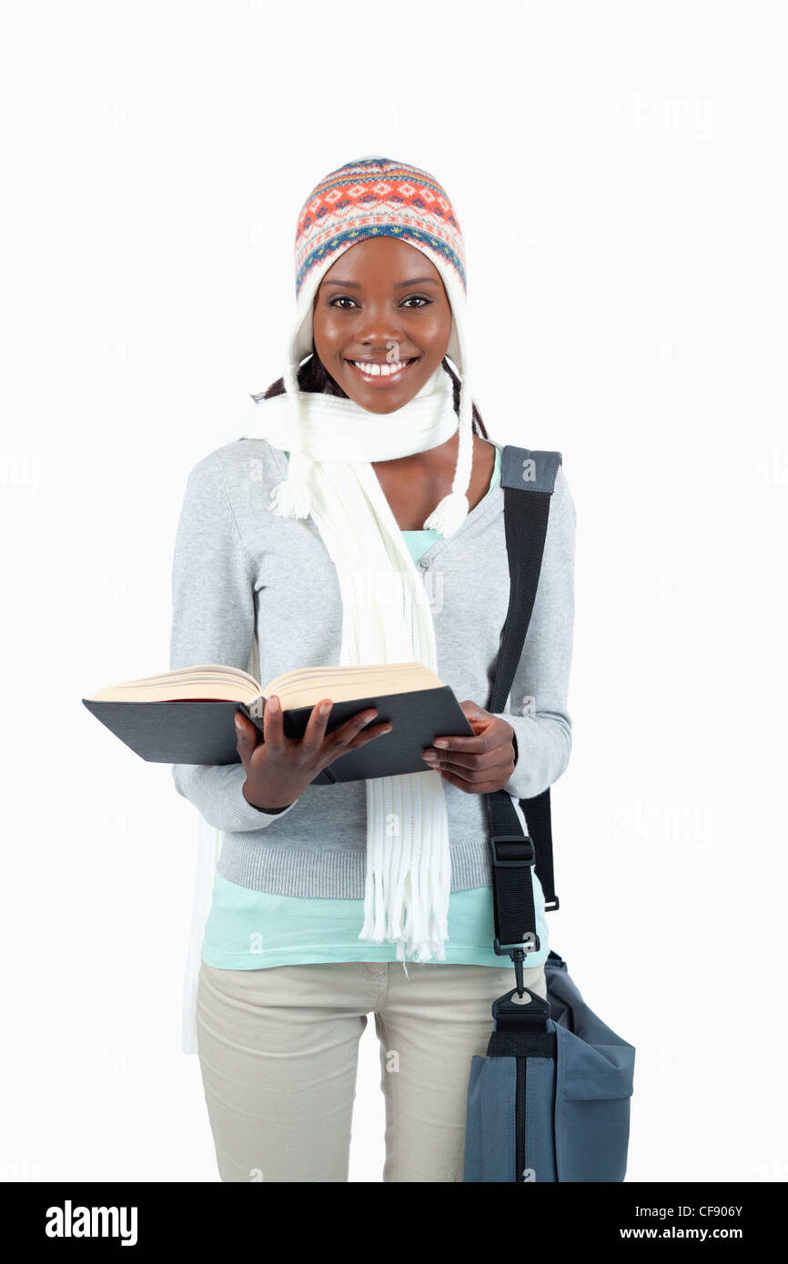 Smiling young student in winter clothing and book Stock Photo - Alamy