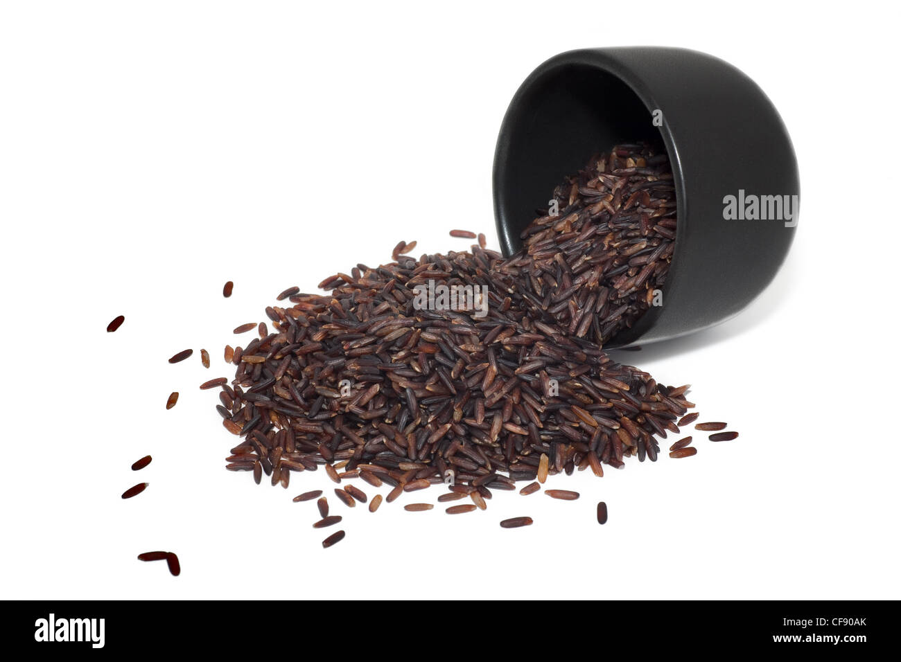 Wild brown rice in bowl and loose over white background Stock Photo - Alamy