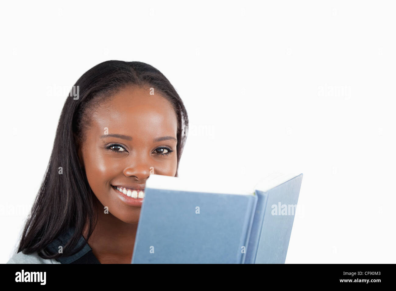 Side view of smiling woman reading a book Stock Photo - Alamy