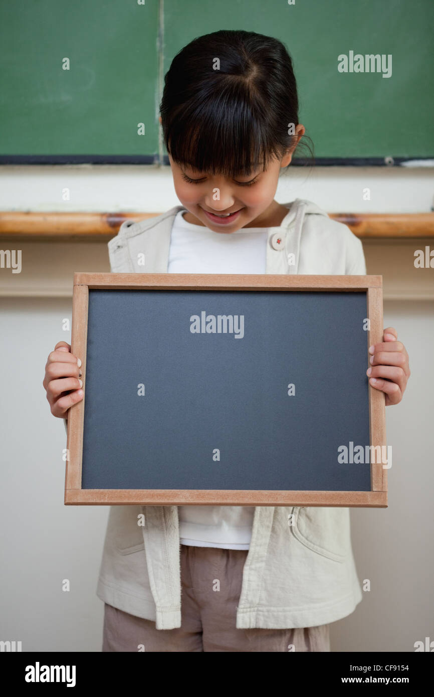 Portrait of a cute girl holding a school slate Stock Photo - Alamy