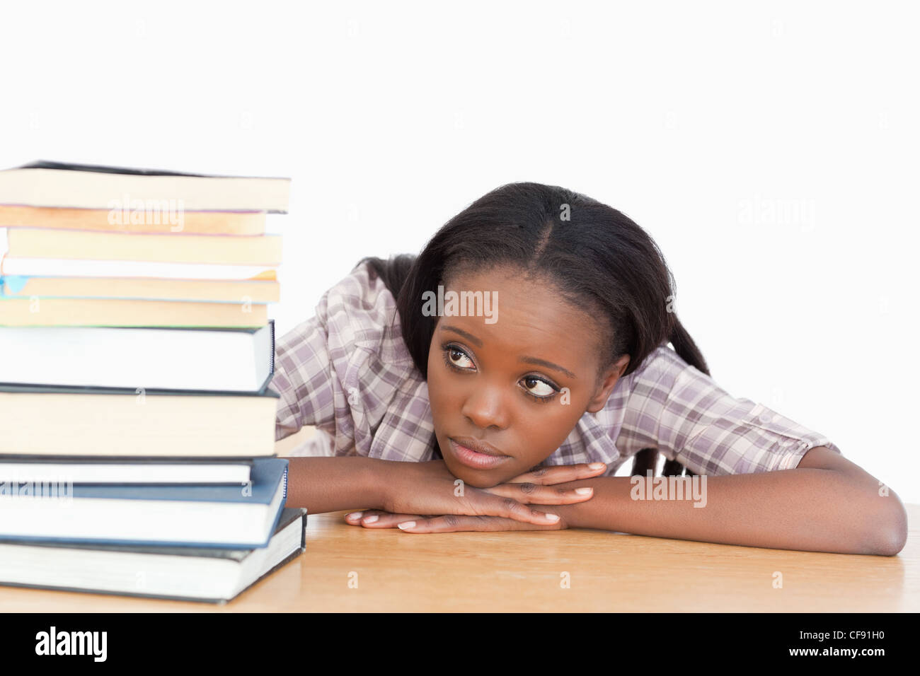 Student looking at a stack of books Stock Photo - Alamy