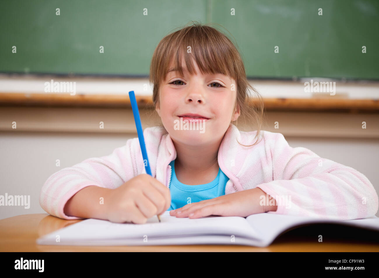 Happy girl writing Stock Photo - Alamy