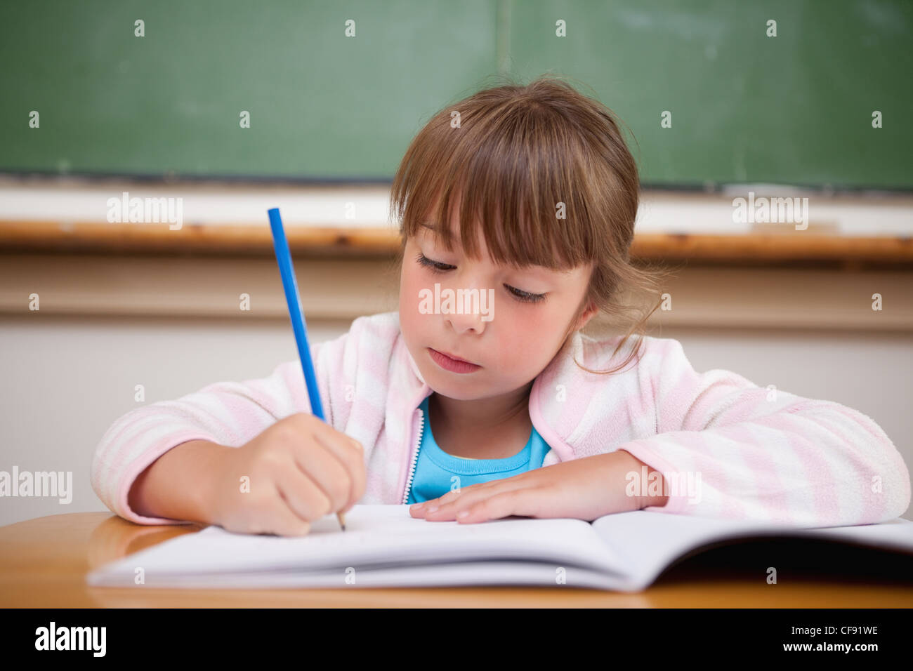 Serious girl writing Stock Photo - Alamy