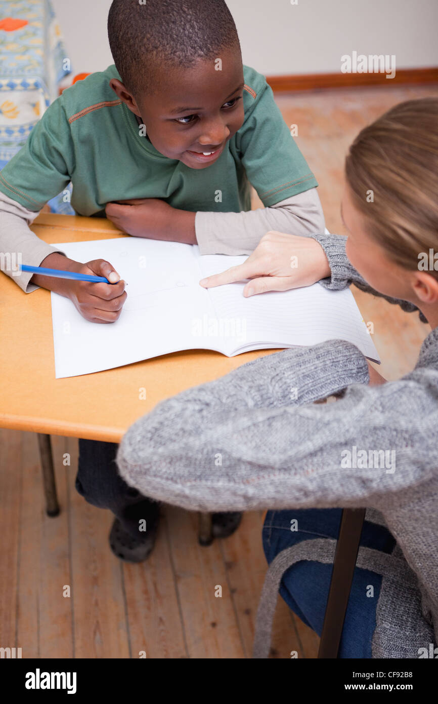 Portrait of a teacher explaining something to a schoolboy Stock Photo ...