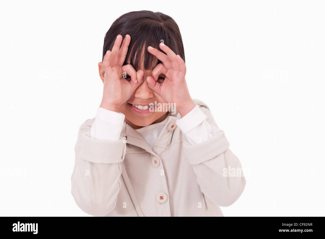 Girl putting her fingers around her eyes Stock Photo - Alamy