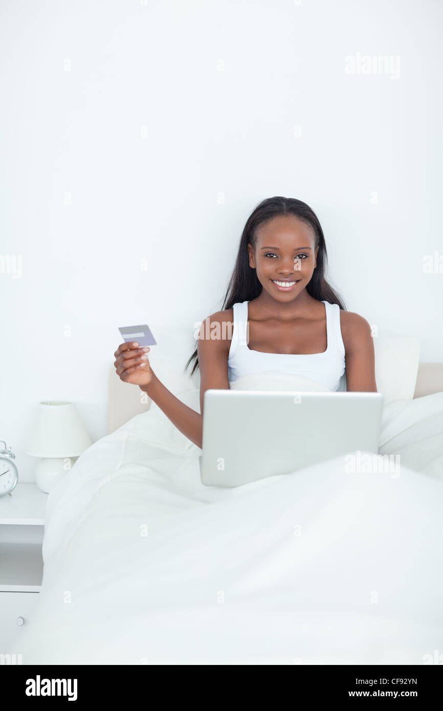 Portrait of a smiling woman booking her holidays online Stock Photo - Alamy