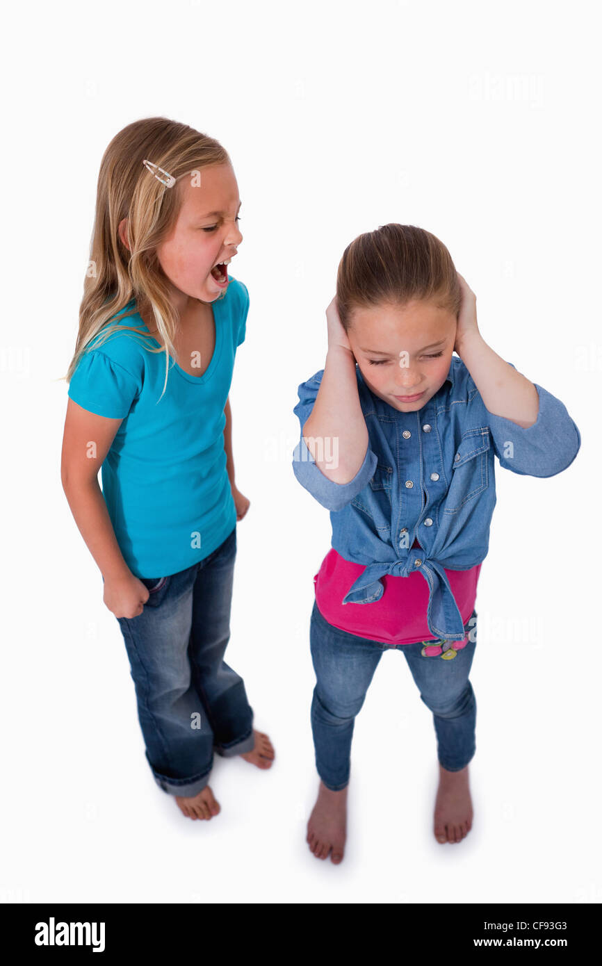 Portrait of an unhappy girl screaming at her friend Stock Photo - Alamy